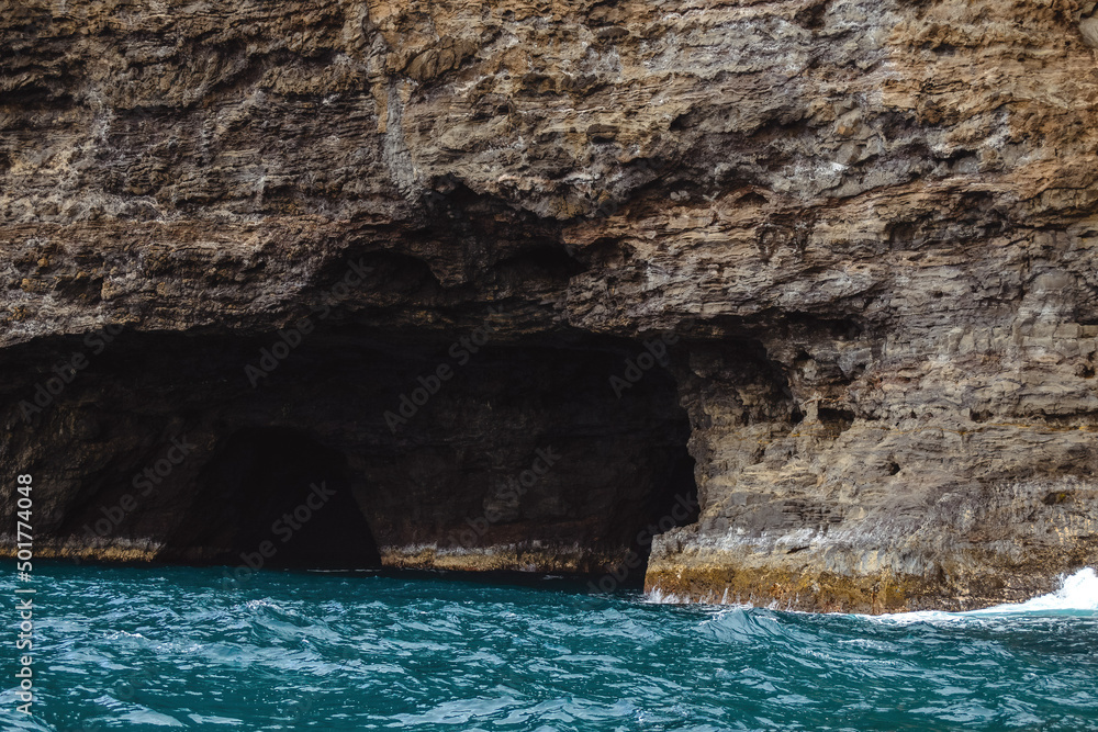 Deep sea caves and rocky formations on the Napali coast of the Hawaiian ...