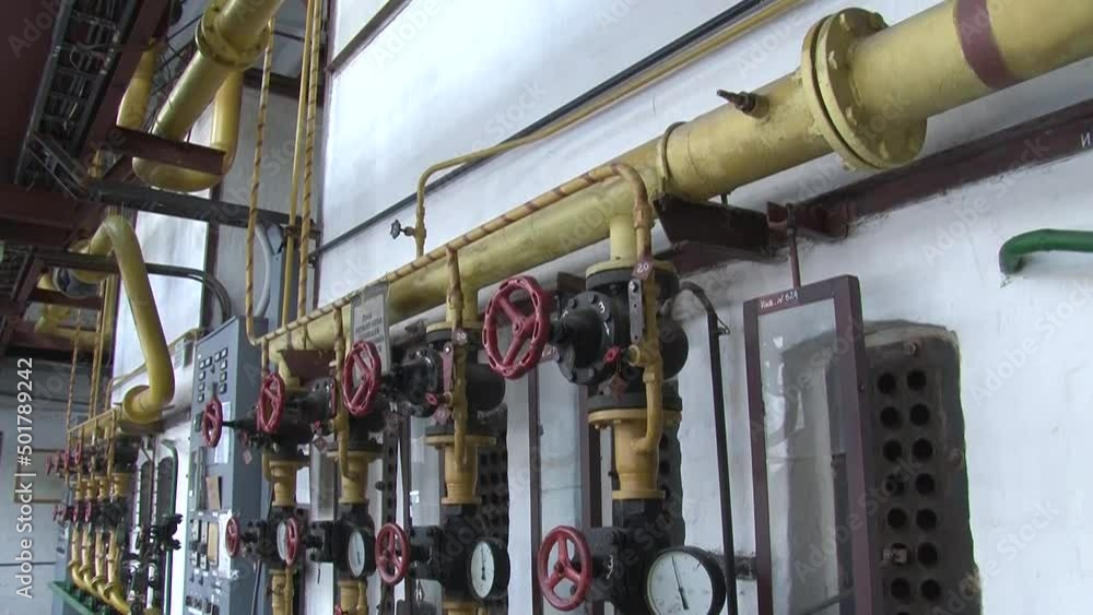 Boiler room with pipes, valves and sensors.Manometer, pipes and faucet ...