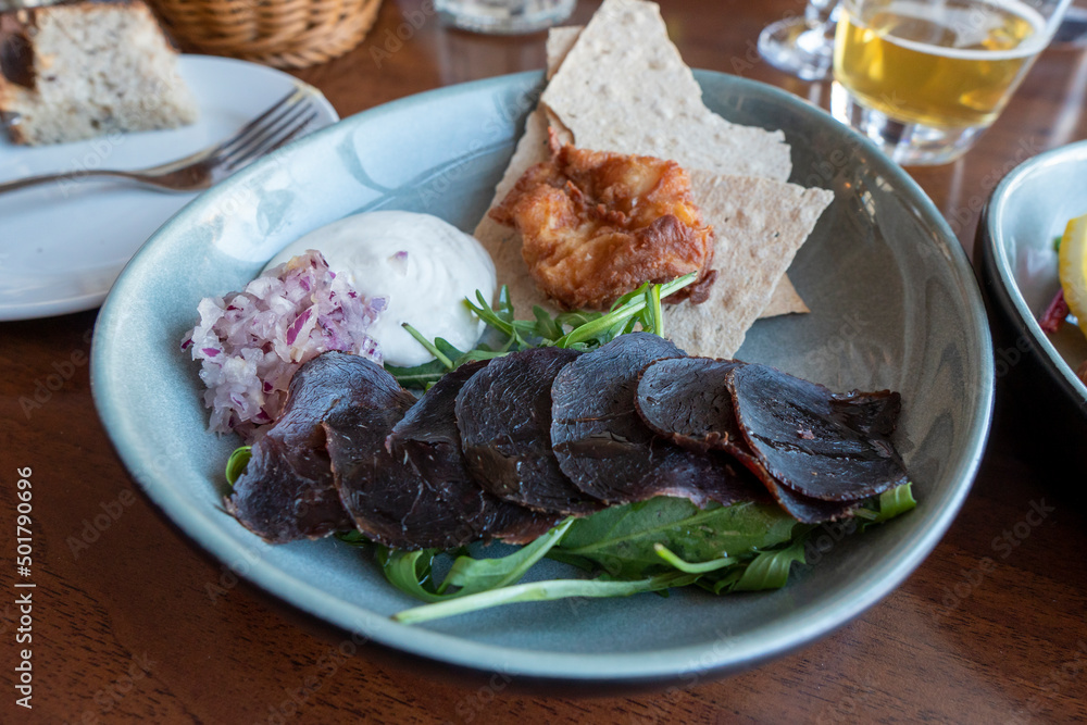 Dried meat of whale and Fried tongue of cod fish with sauce and salad ...