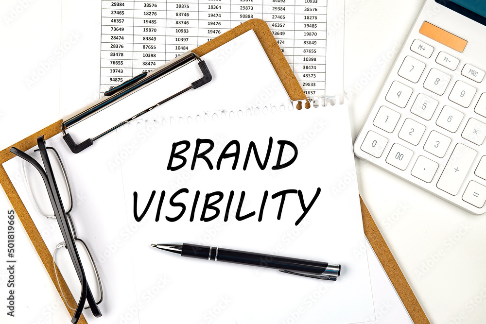 Text BRAND VISIBILITY on the white paper on clipboard with chart and ...