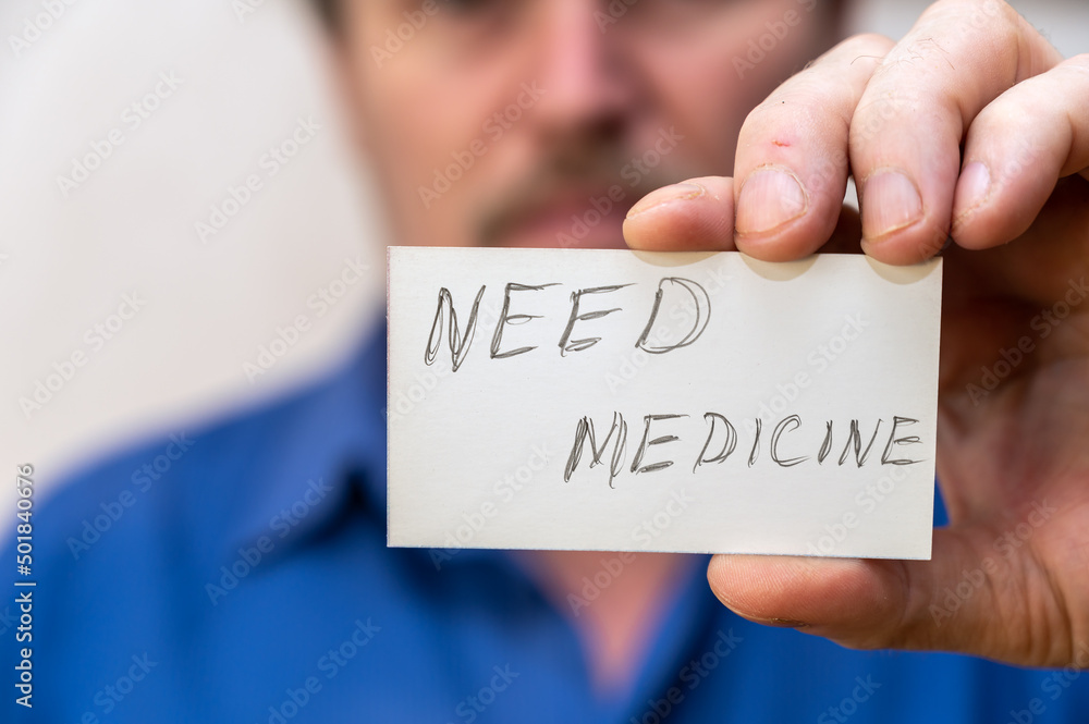 Need medicine. It is written in jagged gray letters on the paper. Man ...