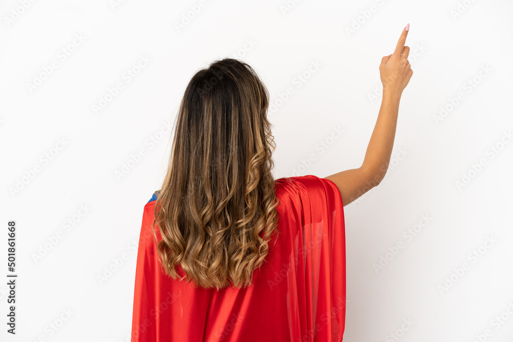 Super Hero woman over isolated white background pointing back with the ...