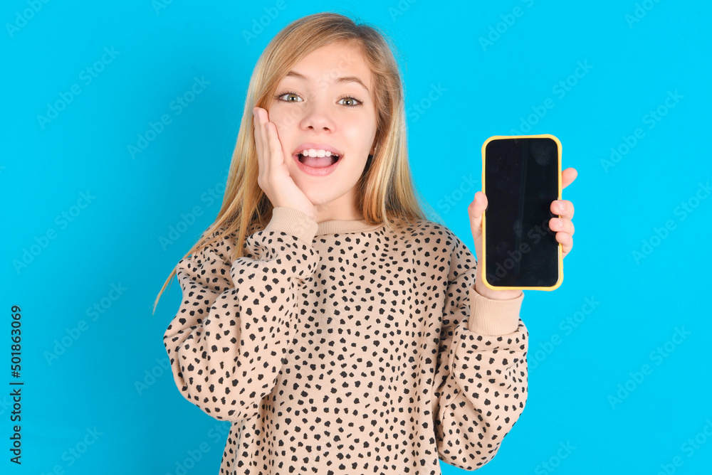 little caucasian kid girl wearing animal print sweater over blue ...