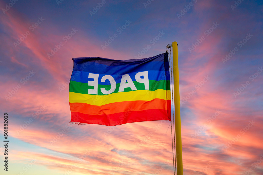 Peace flag waving. The flag in the colors of peace flutters against the ...