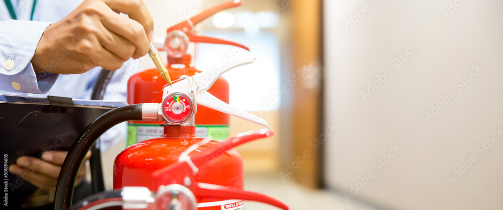 Fire extinguisher has hand engineer inspection checking pressure gauges ...