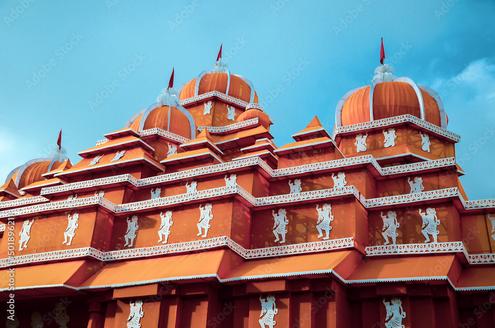 Decorative and colorful pandal of hindu temple against the blue sky ...