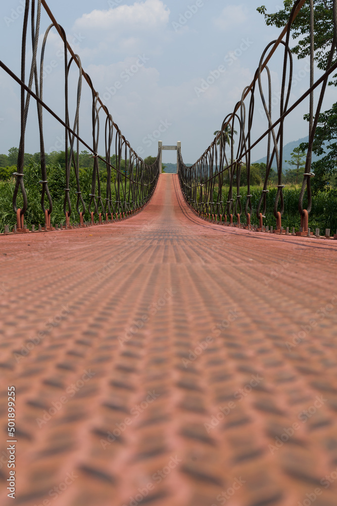 steel bridge suspended by slings for crossing the river.Bridge made of ...