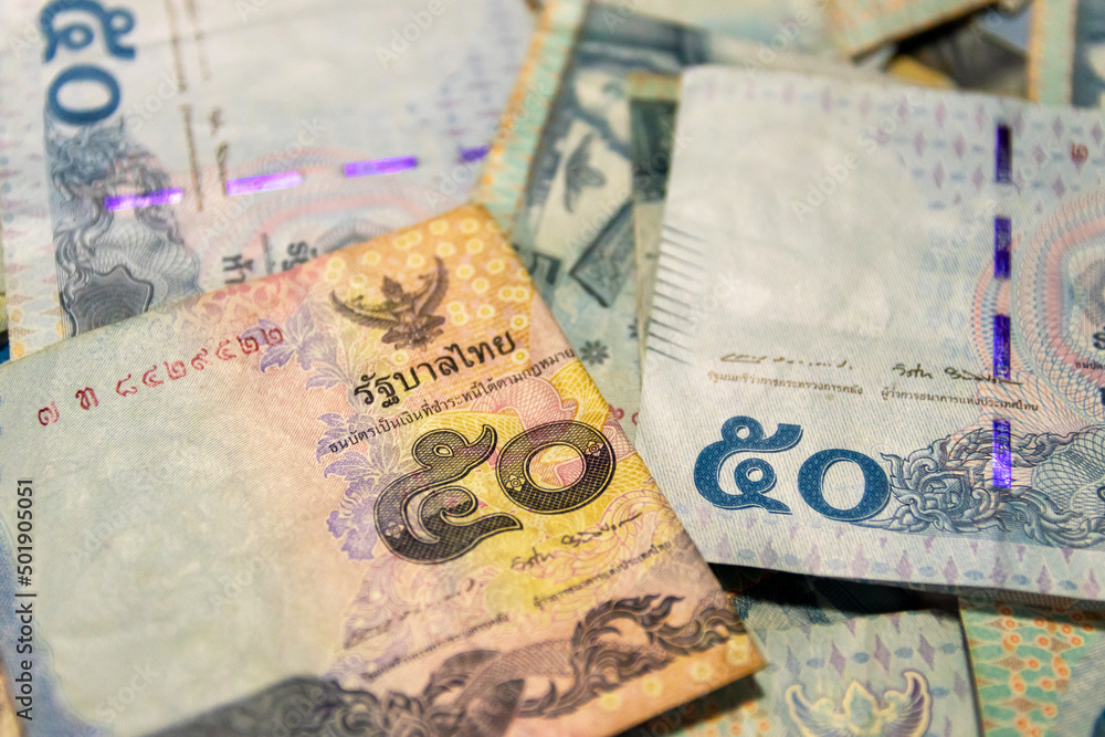 50 Thailand (THB) banknotes. The baht is the official currency of ...