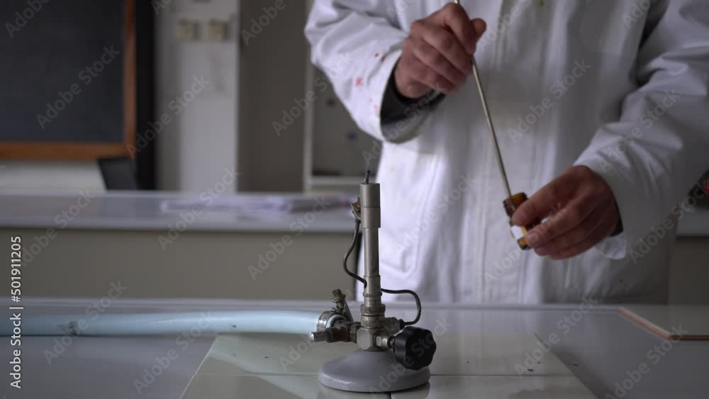Flame test burning into chemistry laboratory. Lithium reaction over ...