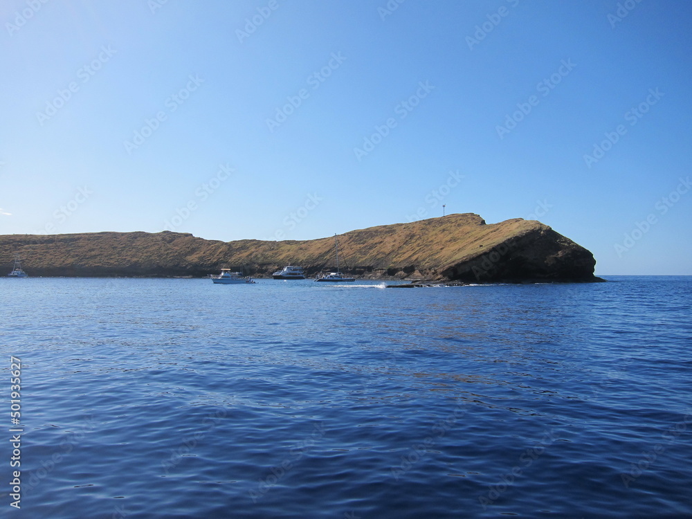 Side view of Molokini, a crescent-shaped volcanic crater and small ...