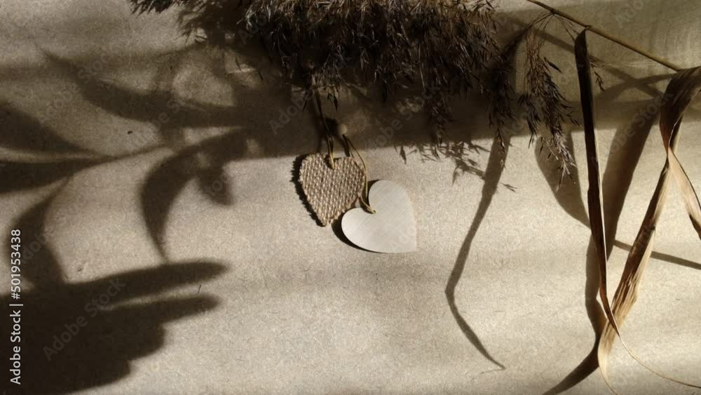 Blurred shadow of female hand with leaves on golden beige wall ...