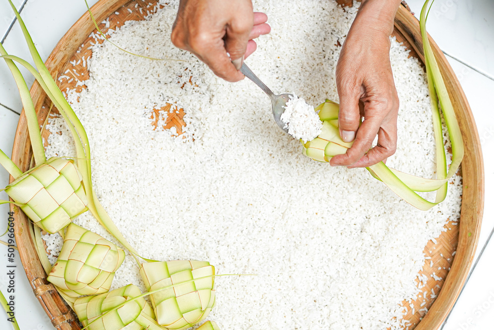 The process of making ketupat is a traditional food during Eid. Put the ...