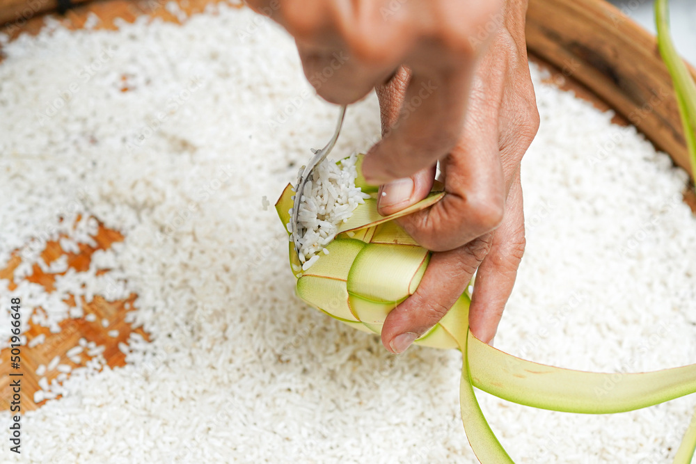 The process of making ketupat is a traditional food during Eid. Put the ...