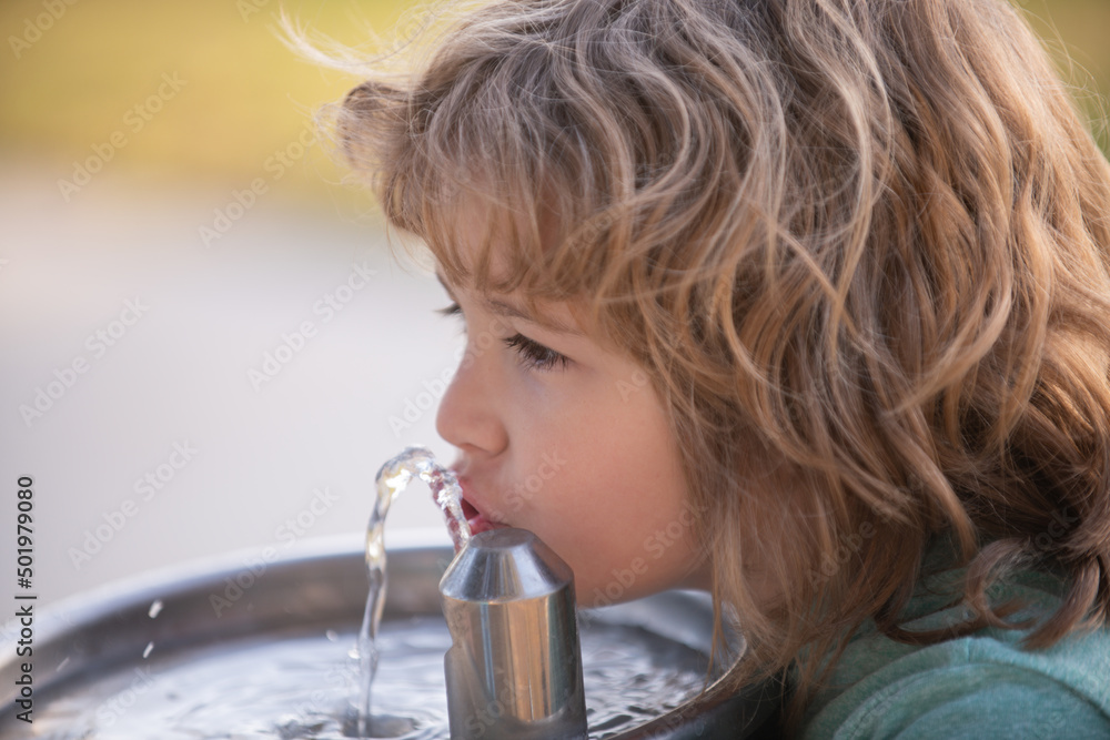 Kid drinking water from a water fountain in park. Thirsty child. Stock ...