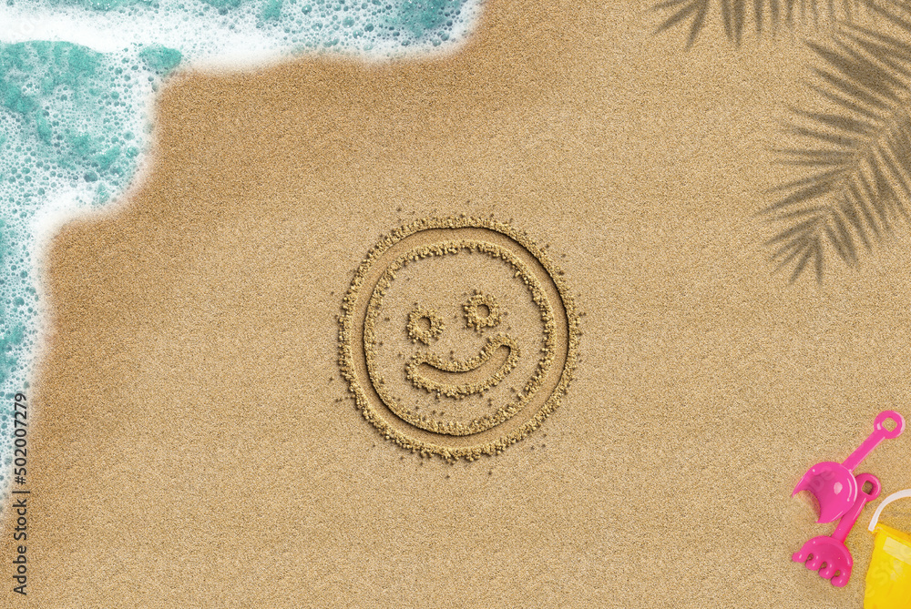 Smiley face drawn on sandy beach, travel and holiday concept, emoji ...