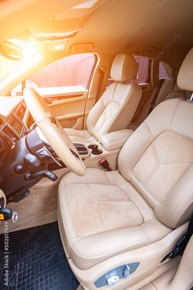 Car interior luxury. Beige comfortable seats, steering wheel, dashboard ...