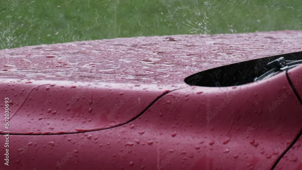 Slow motion close-up of the falling rain and the bouncing raindrops on ...