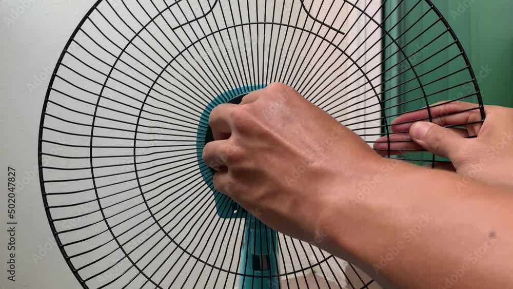 Video Stock Tighten black plastic nut at rear grille bar on blue desk ...