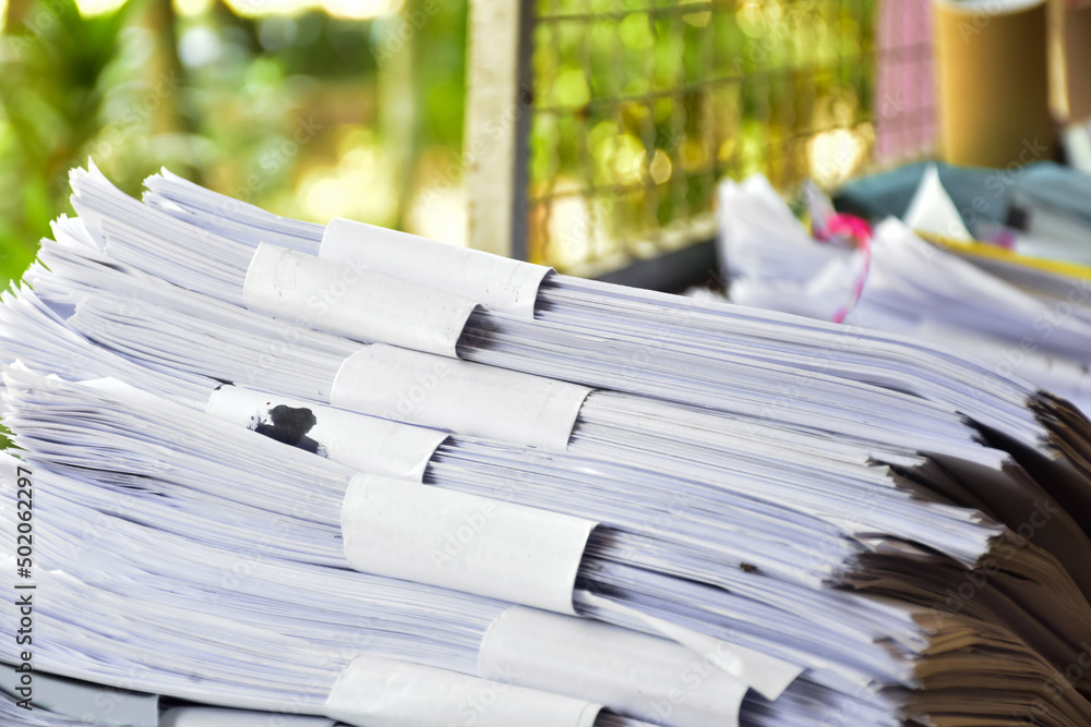 Used white paper is bundled together in piles infront of the bulcony to ...