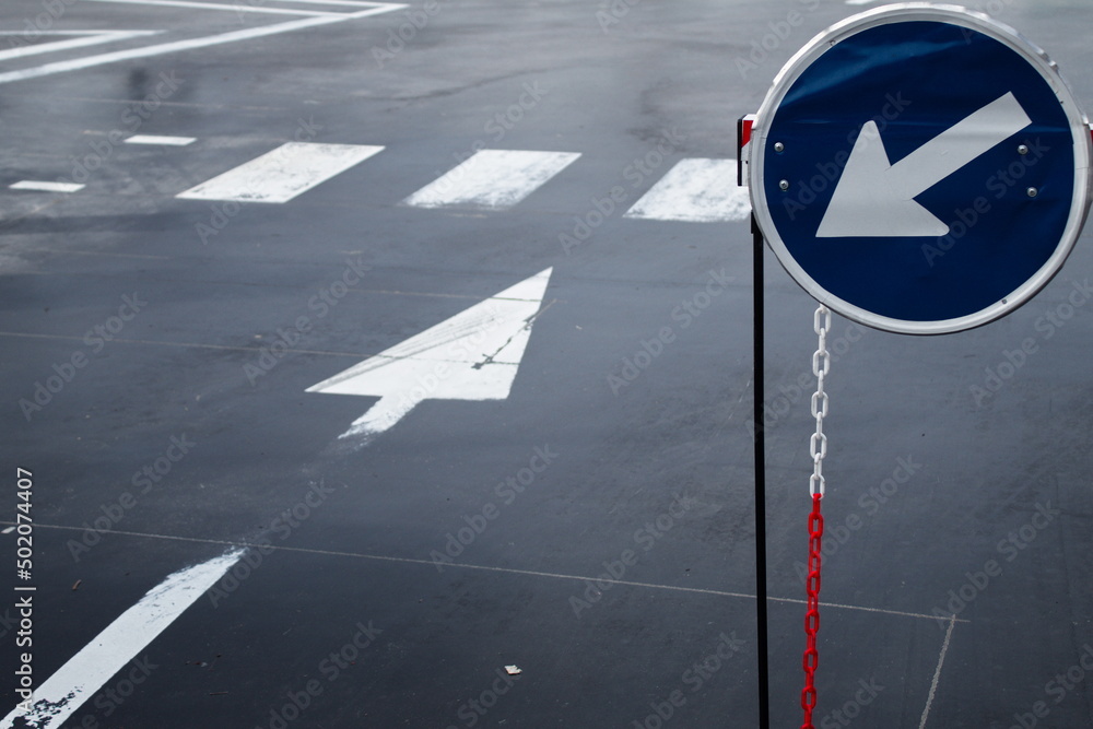 Set of road signs on the ground and with discs to facilitate driving ...