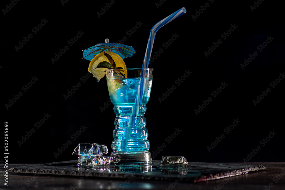 Cocktail Blue Lagoon, ice on bar counter in a restaurant, pub. Fresh ...