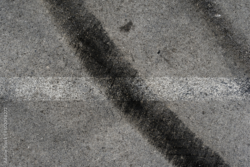 Asphalt texture with white line and tire marks. Smooth asphalt road ...