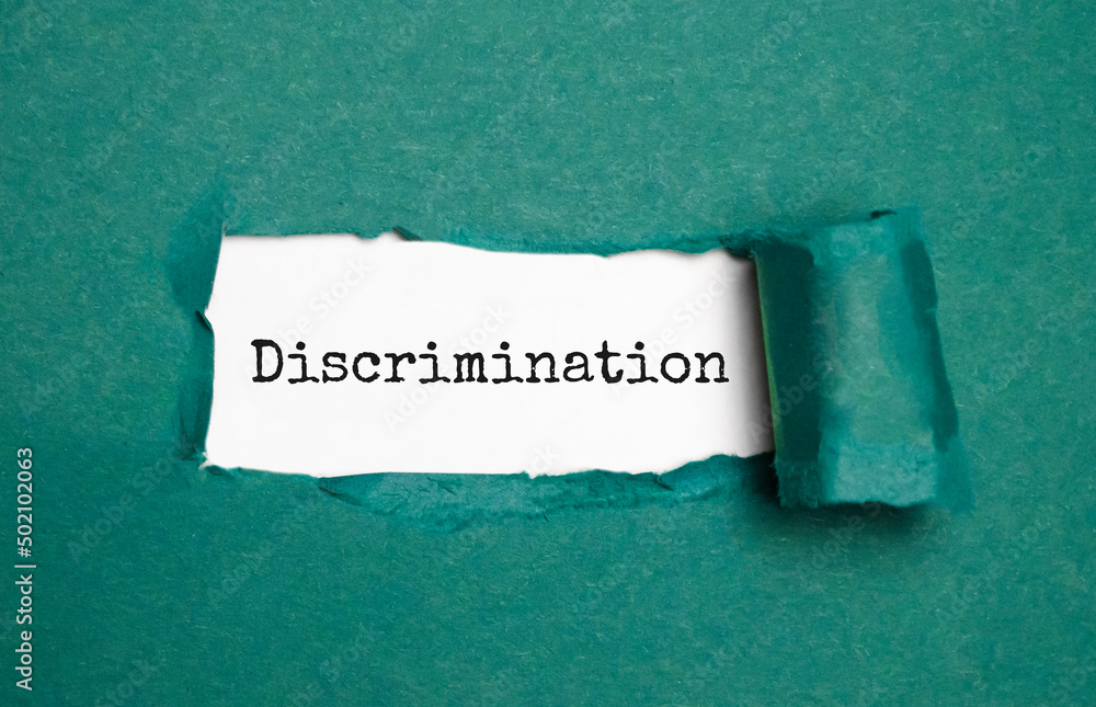 The text Discrimination appearing behind torn green paper Stock Photo ...
