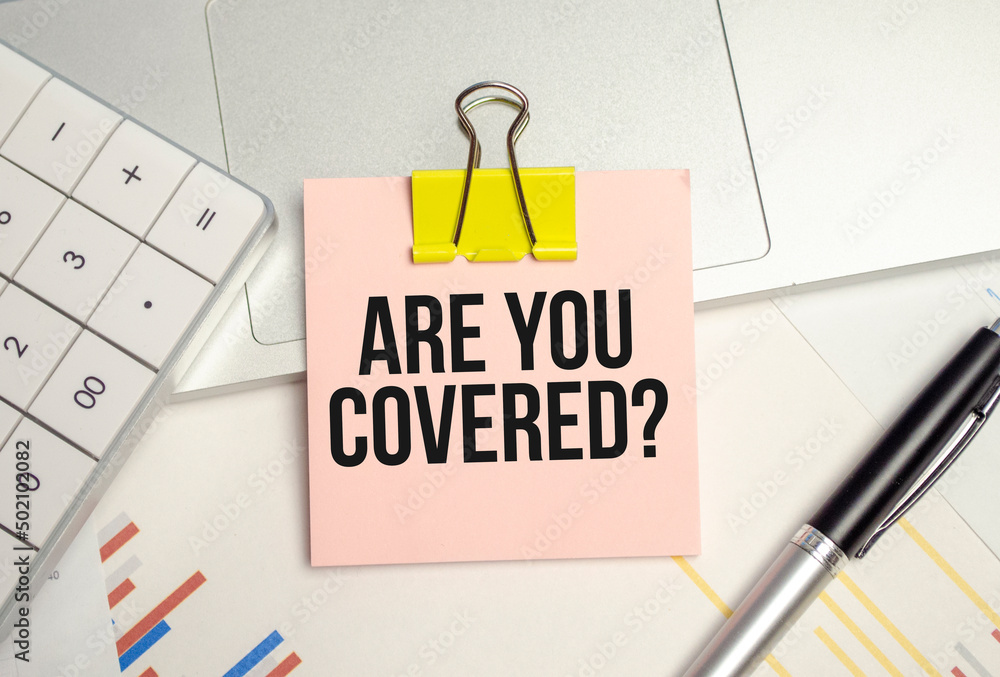 Text ARE YOU COVERED on stickers on the charts with office tools Stock ...