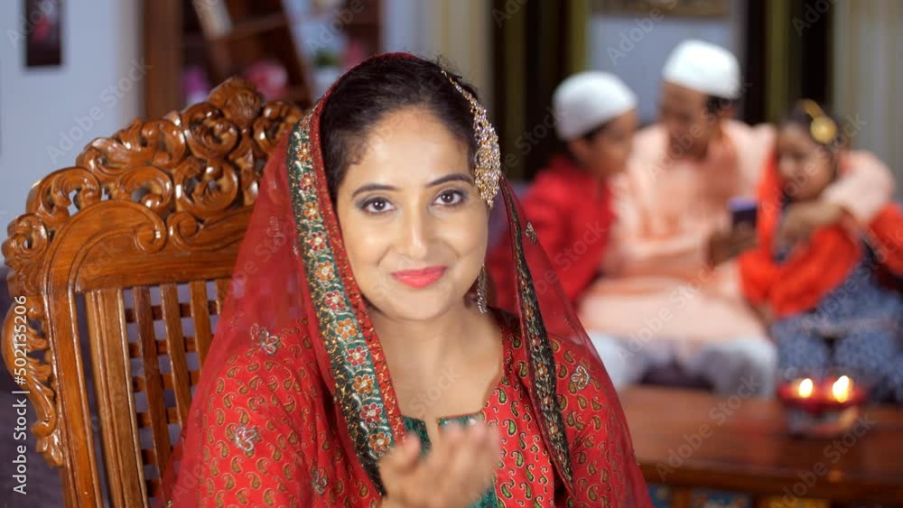 A beautiful Muslim lady wearing a headscarf doing a Saalam-Alaikum ...