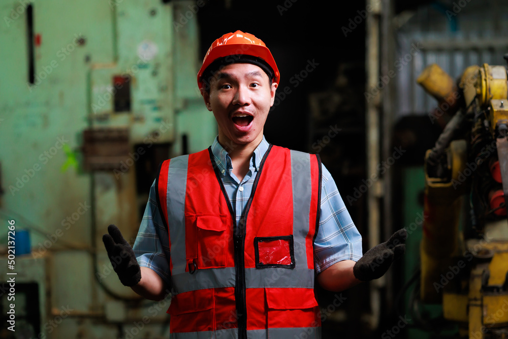 Portrait Happy Asian man worker look at camera thumps up. Metal machine ...