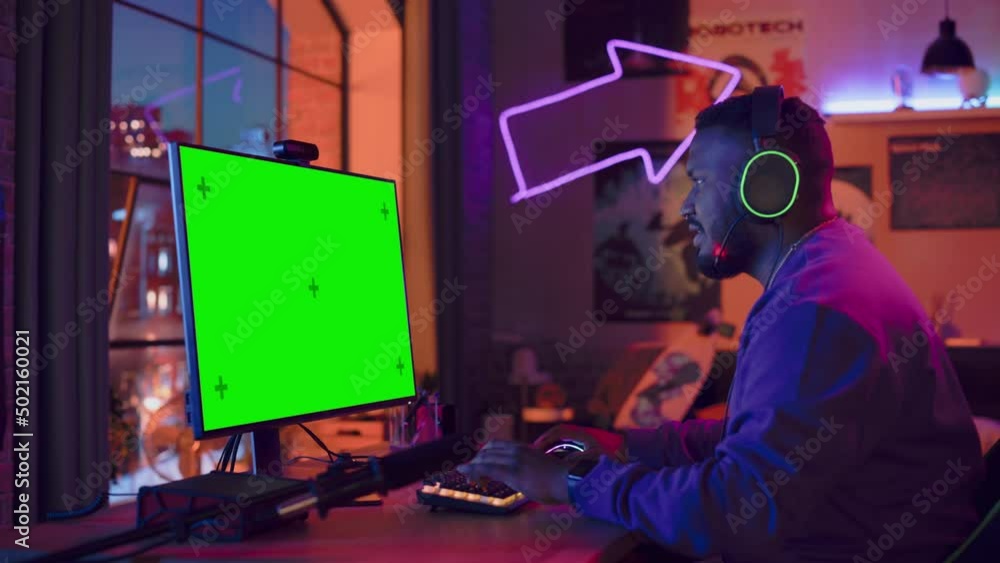 Excited Gamer Playing Online Video Game with a Mock Up Green Screen on ...
