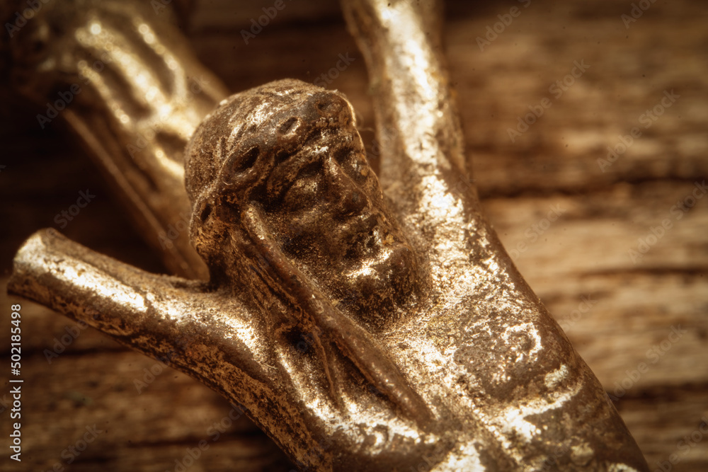 Partially destroyed ancient statue of the crucifixion of Jesus Christ. Selective focus ...