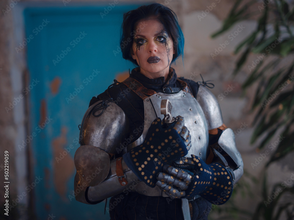 Medieval knight woman in armor prays, blessing before the battle. Stock ...