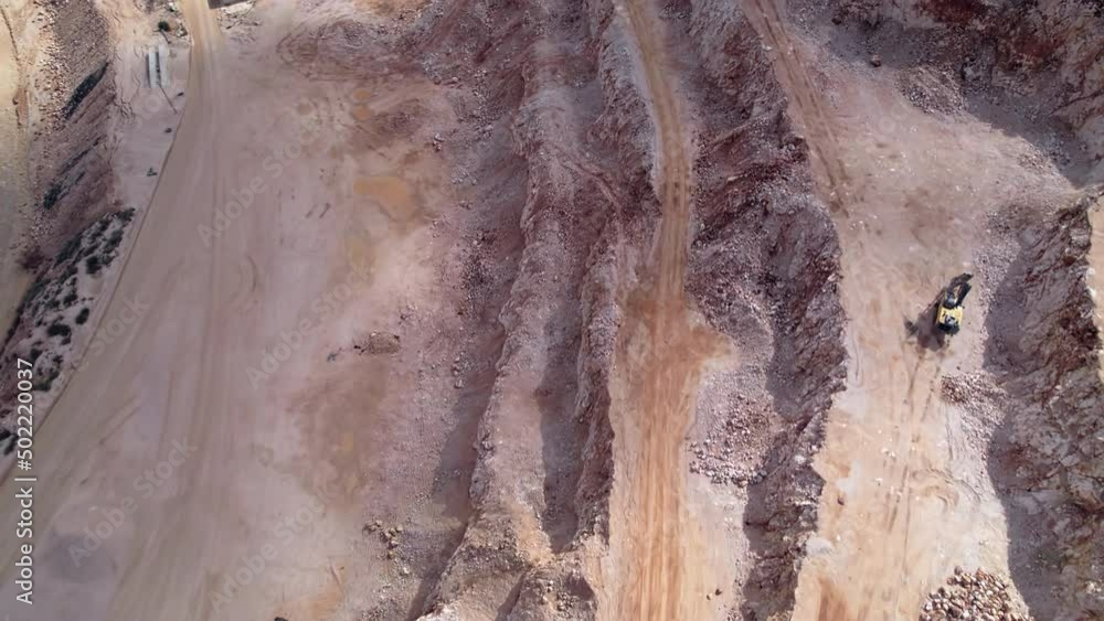 Terraces of opencast mining. Drilling rig on the quarry ledge top down ...