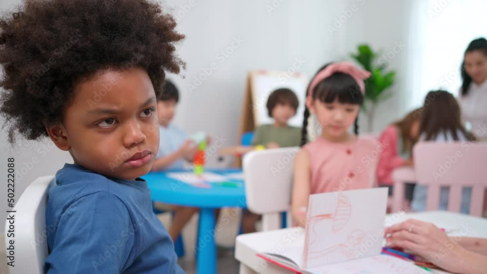 African American sitting in the kindergarten classroom during drawing ...