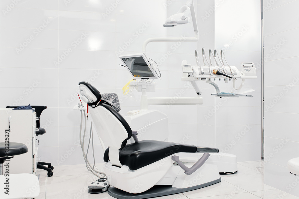 Dentist's dental office interior with unit, tools, lamps, ergonomic chair Stock Photo | Adobe Stock