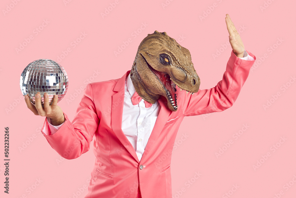 Cheerful, stylish and fashionable man in dinosaur rubber mask with ...