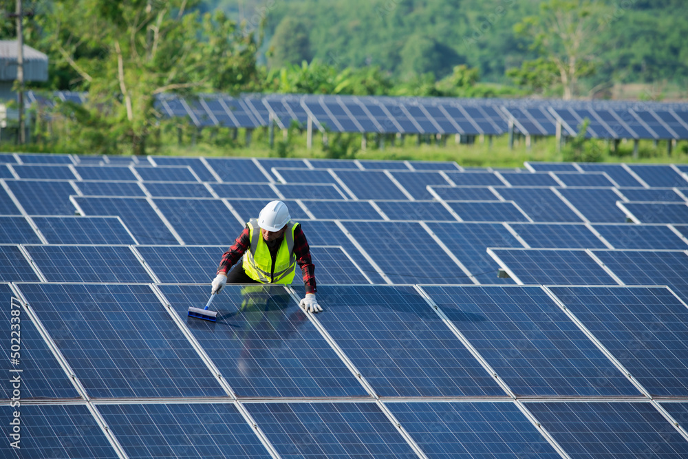 Cleaning solar panels by workers in uniform safety at solar farm Stock ...
