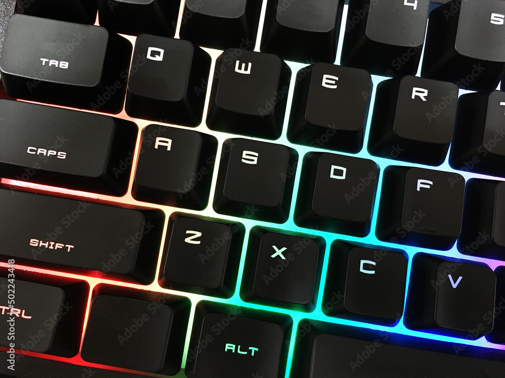 Modern gaming keyboard with bright backlit keys on the table Stock ...