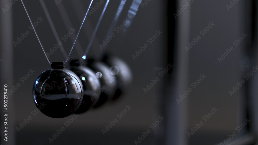 Newton's cradle physics concept for action and reaction or cause and ...