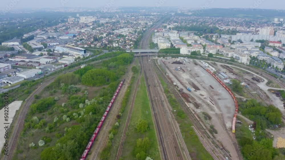 Electric locomotive with freight red cars or railway wagon rides on ...