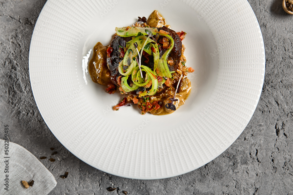 Braised beef cheeks with pearl barley and celery in creamy mushroom ...