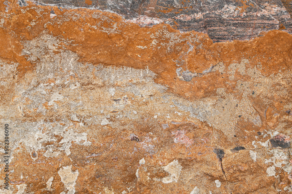 An image of a real rock wall texture with orange and red color and ...