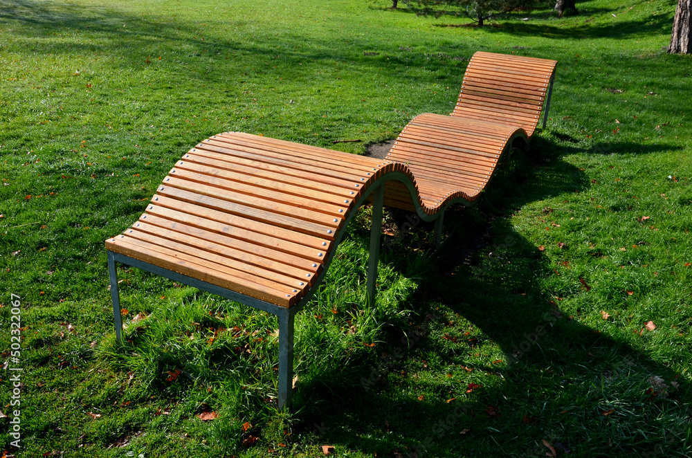 design bench in the shape of a wavy line. wooden paneling on a metal ...