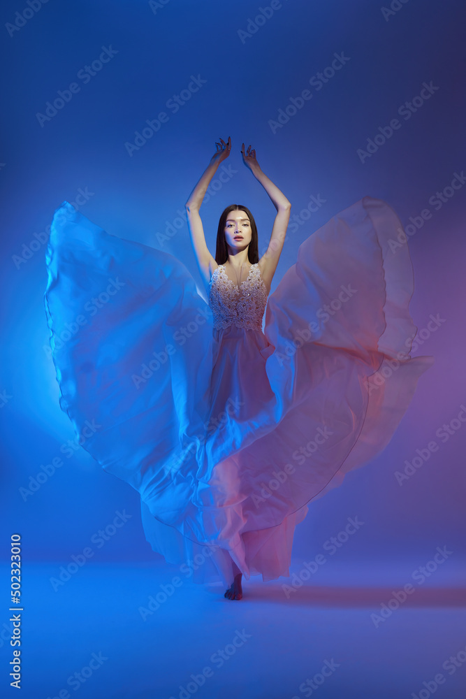 Art beautiful woman in blowing flying dress. Freedom concept in neon ...
