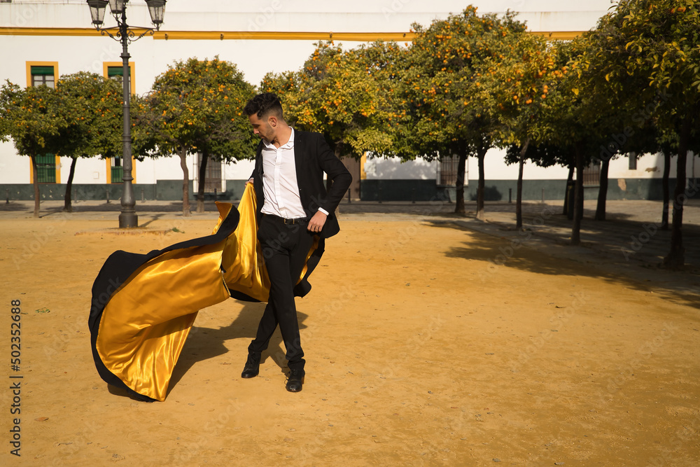 Young Spanish man in black shirt, jacket and pants, with dancing shoes ...