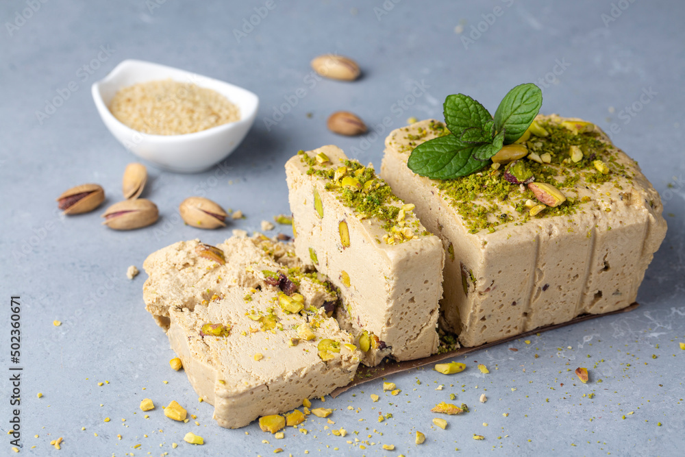 Sesame halva with pistachios on grey background. Top view. Copy space ...