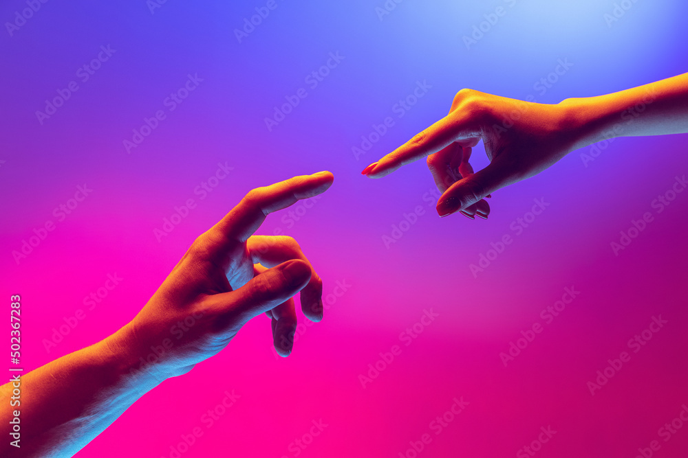 Two human hands trying to touch each other isolated on gradient blue ...