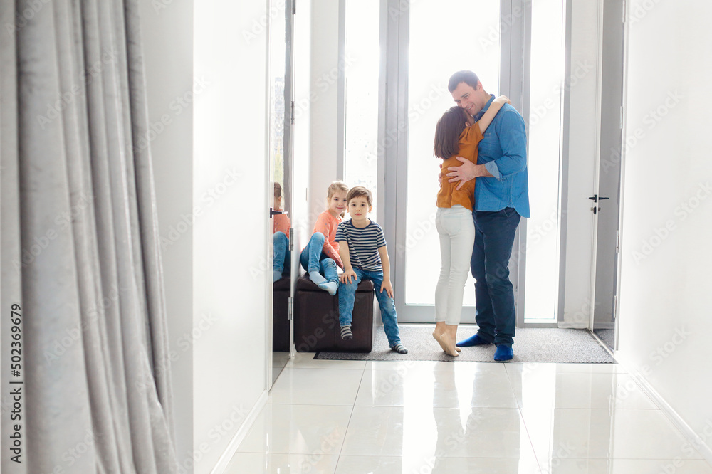 Happy father returned home after a business trip, dad hugging little ...