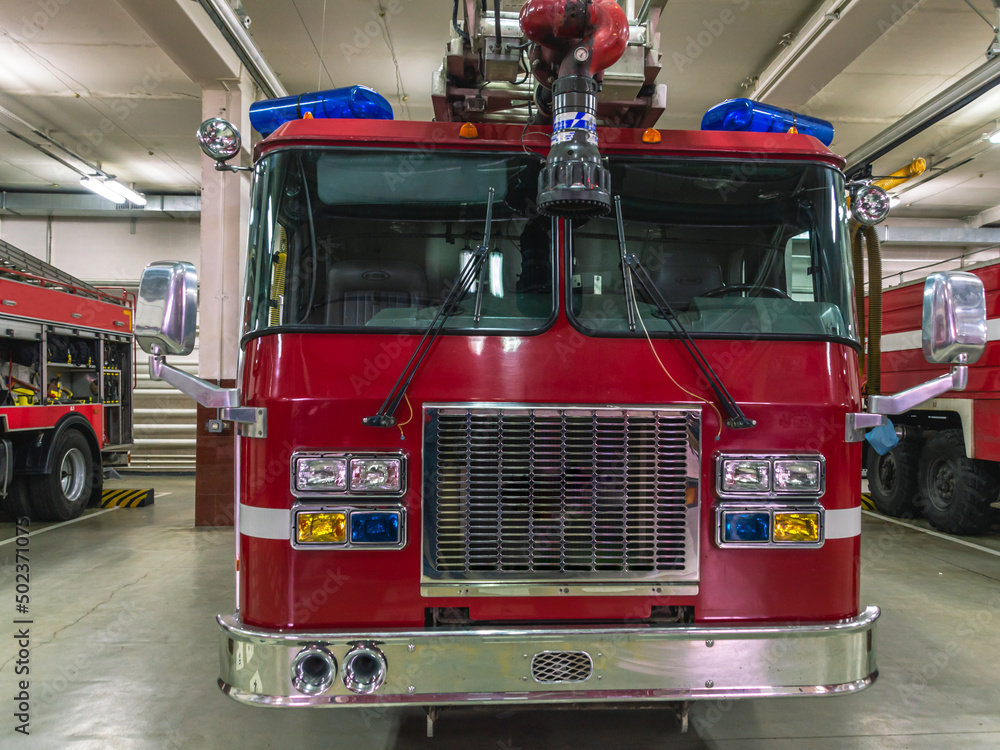 Fire truck with retractable ladder for extinguishing fires at height. A ...